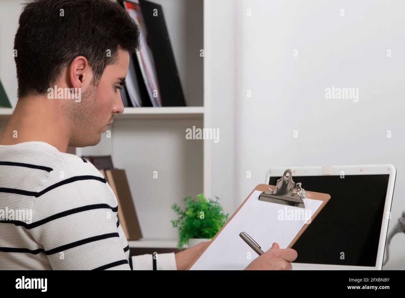 young man studying at home on your desktop with laptop computer Stock ...