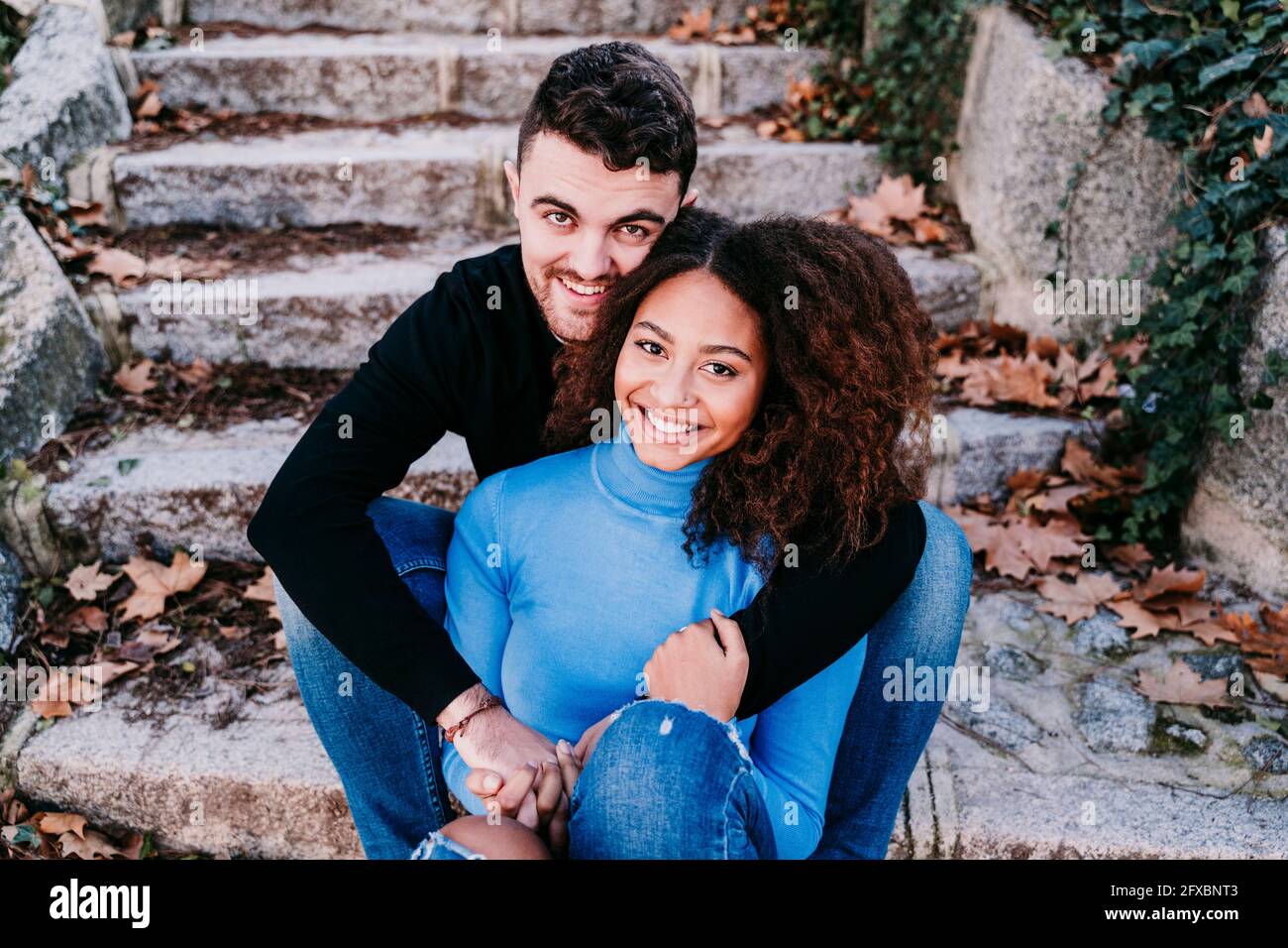 Young multiethnic couple sitting hi-res stock photography and images ...