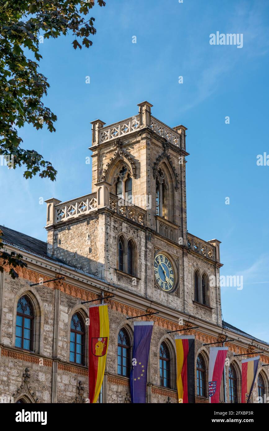 Germany, Thuringia, Weimar, Town hall with clock, carillon and flags ...