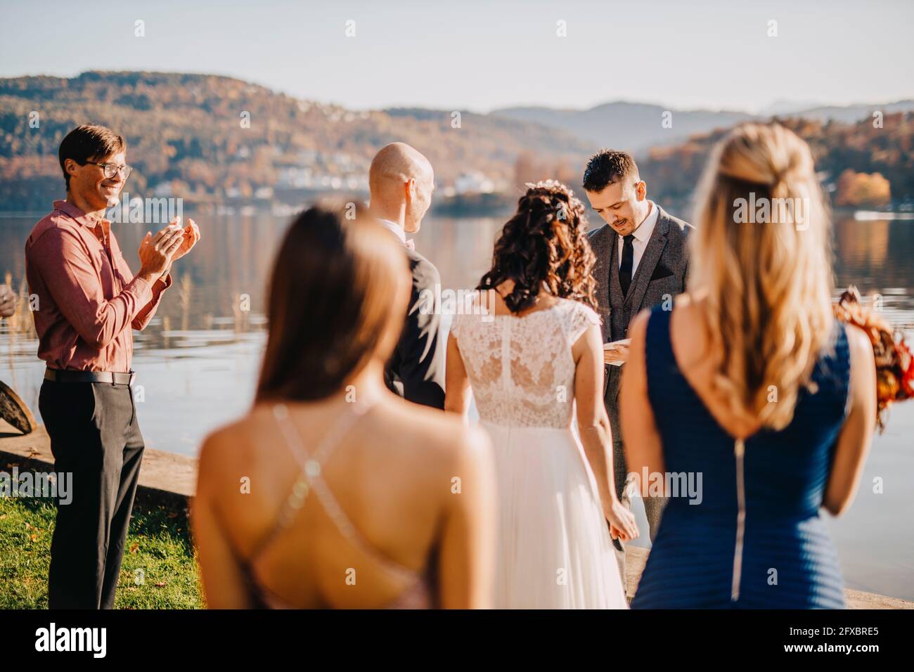Wedding couple with guests at ceremony Stock Photo - Alamy