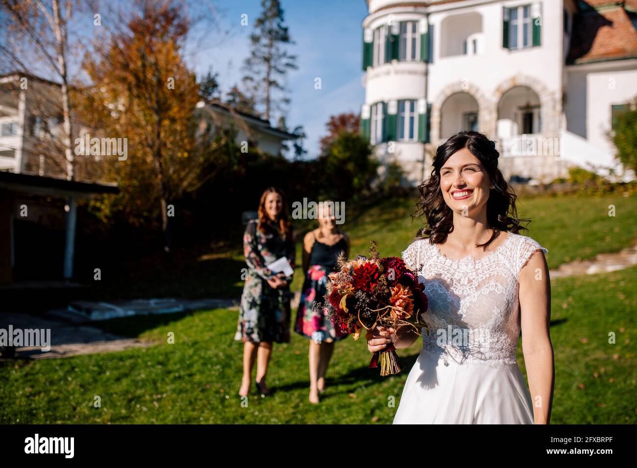 Beautiful bride standing on lawn at wedding ceremony Stock Photo - Alamy