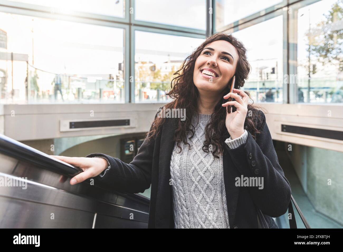 Woman moving up an escalator hi-res stock photography and images - Alamy