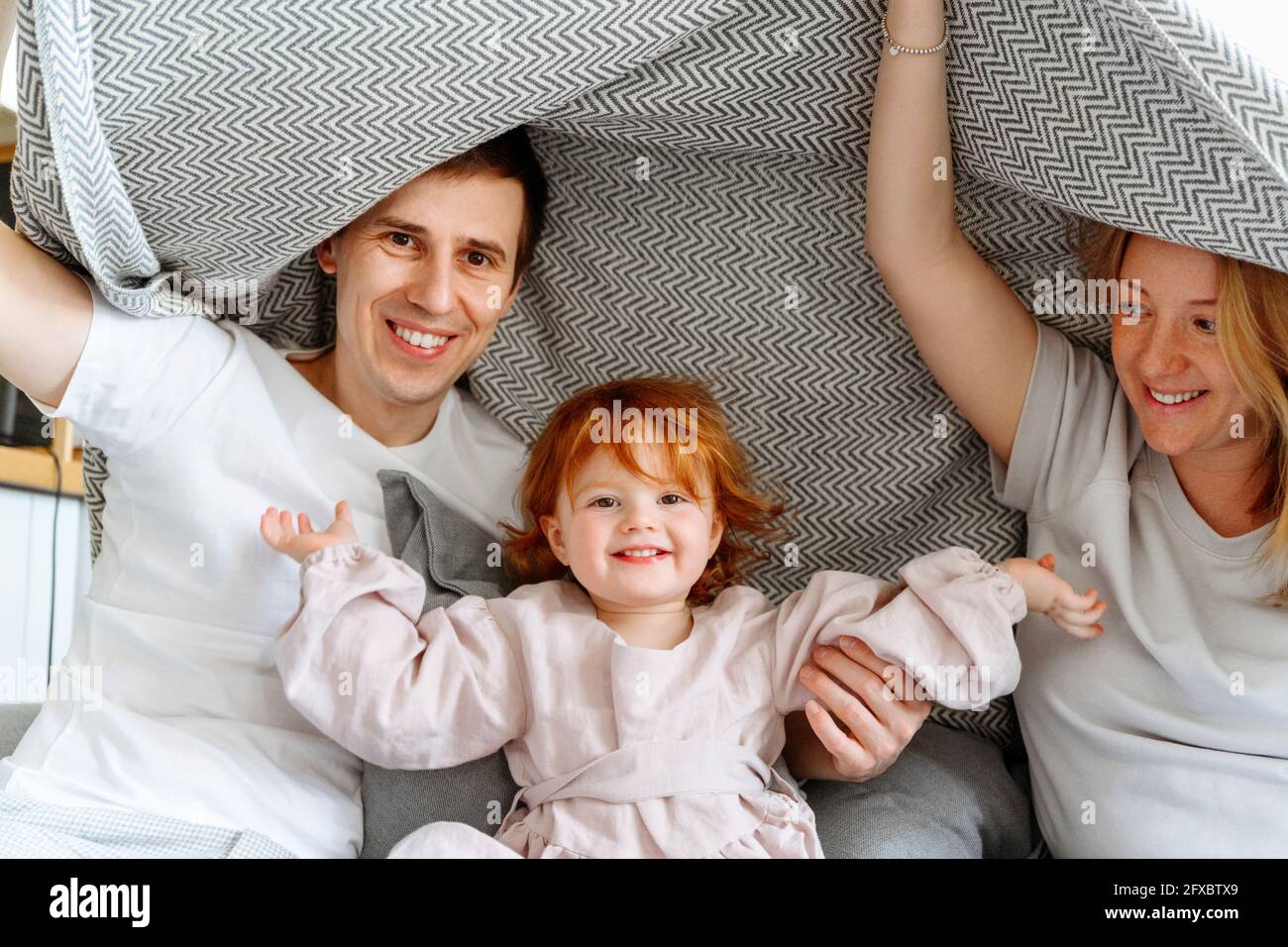Family playing under blanket on bed at home Stock Photo - Alamy
