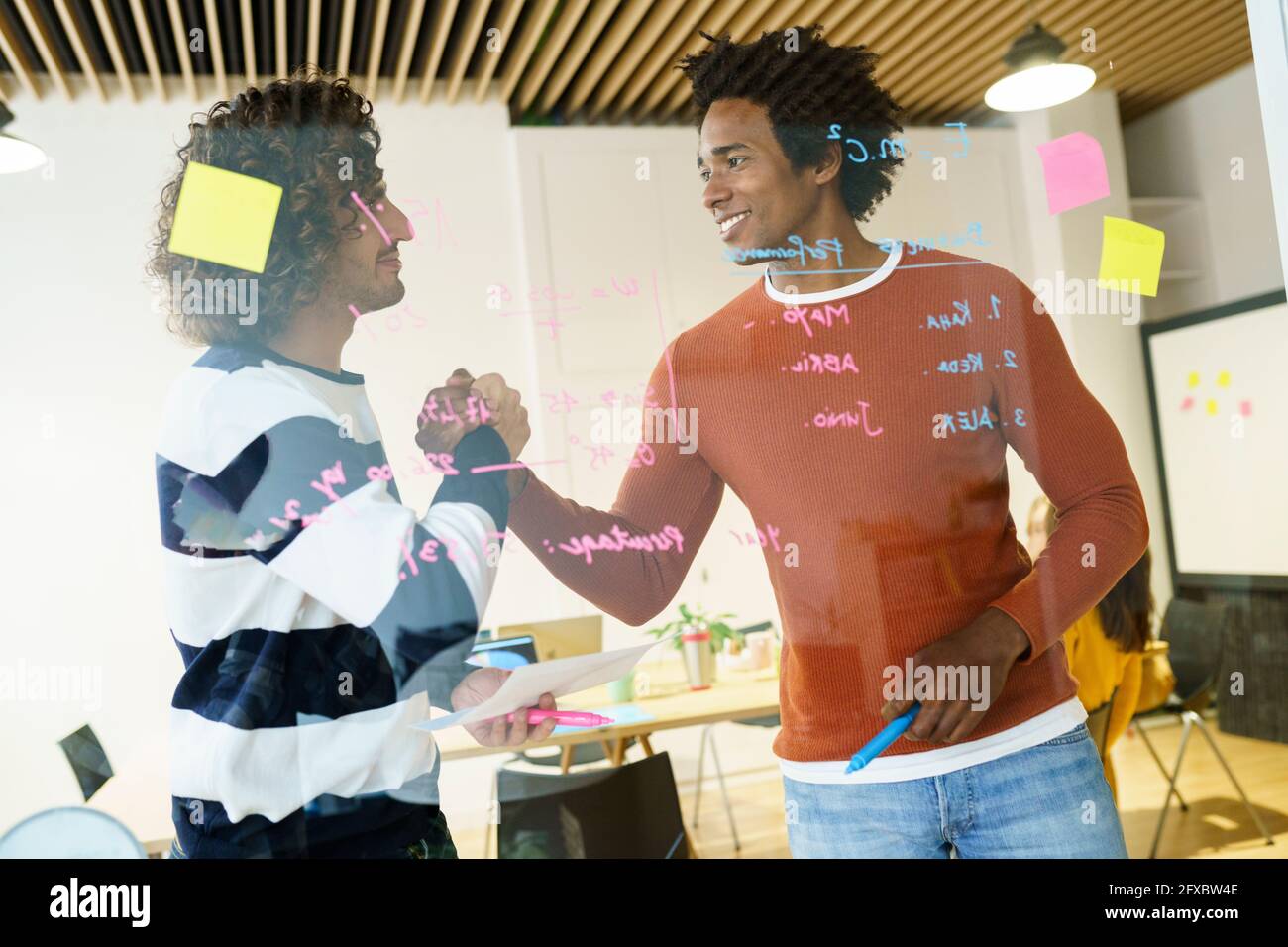Business colleagues greeting during meeting in office Stock Photo - Alamy