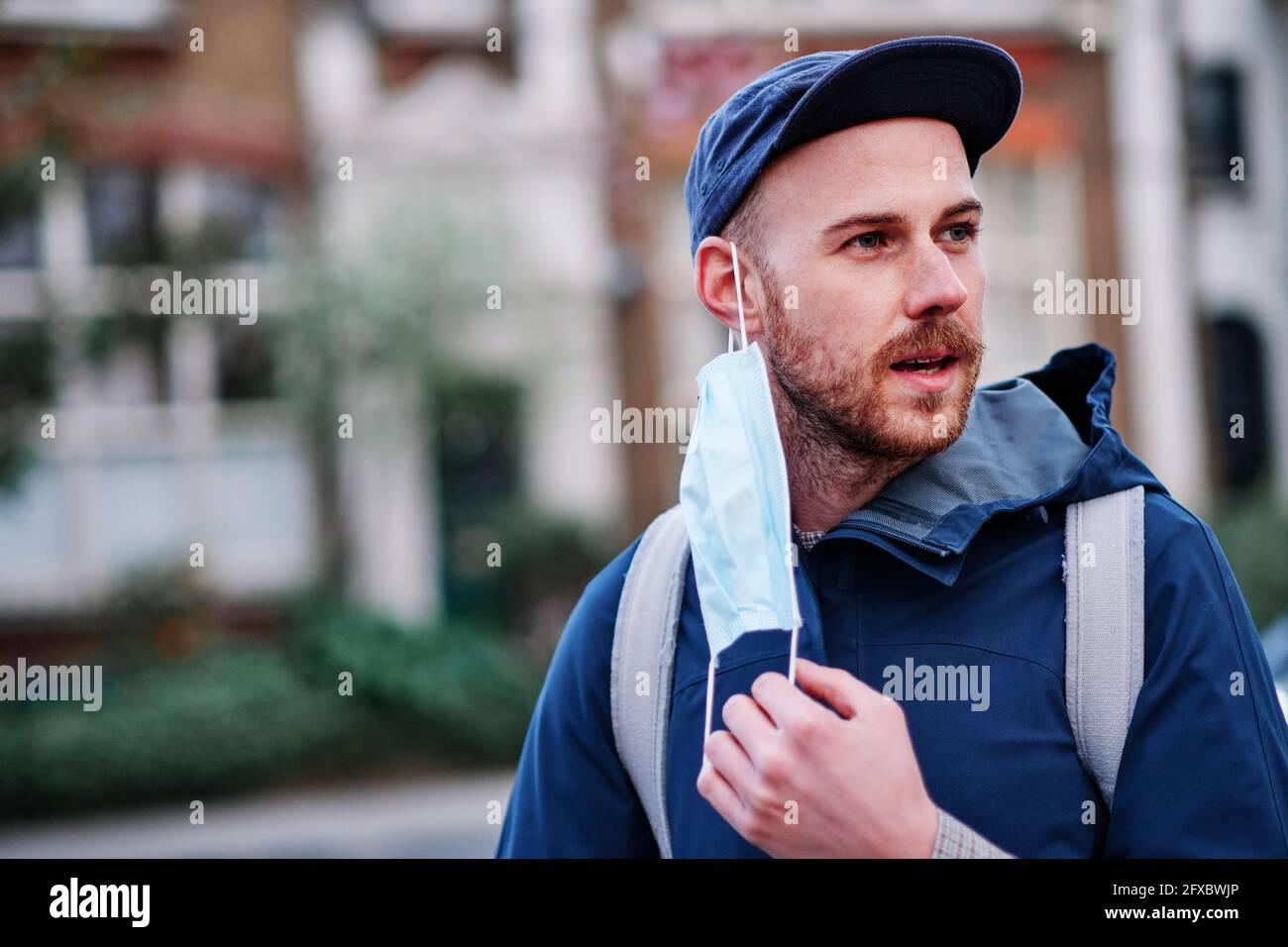 Young man cap removing face hi-res stock photography and images - Alamy