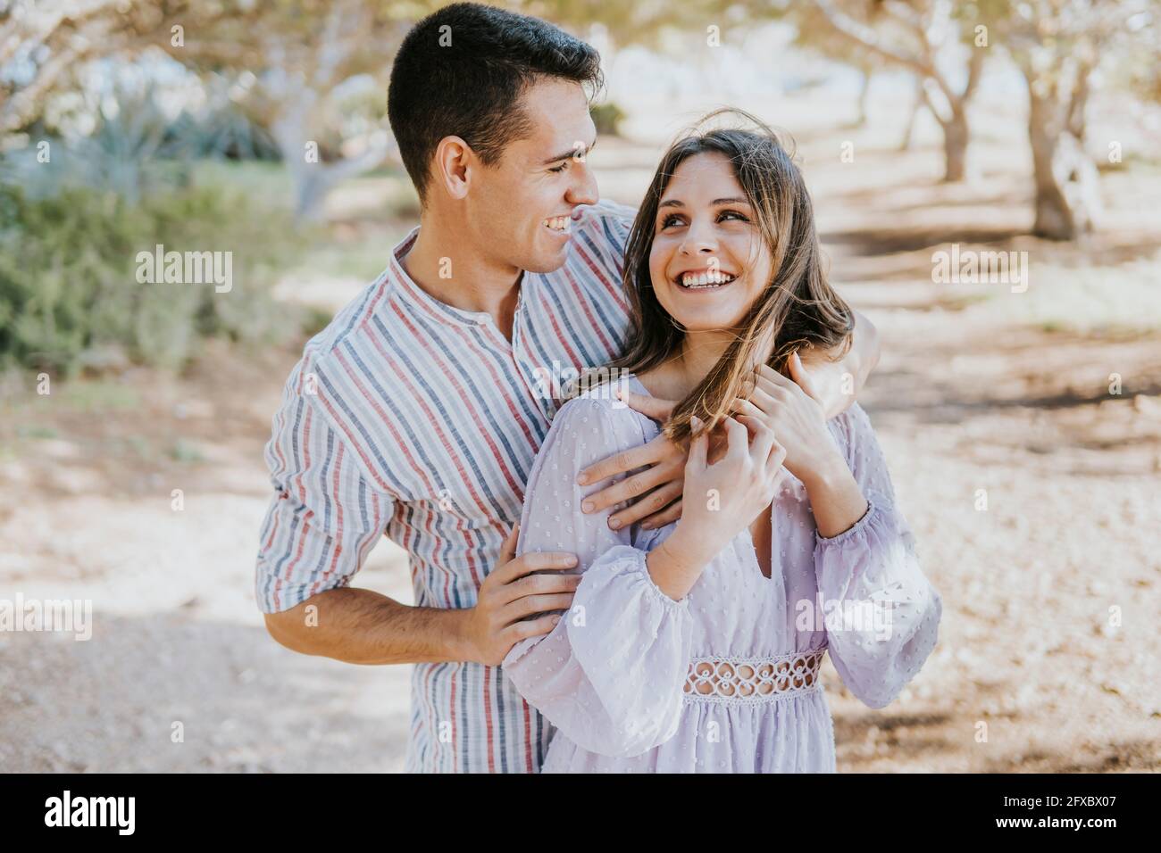 Smiling girlfriend looking at boyfriend Stock Photo - Alamy