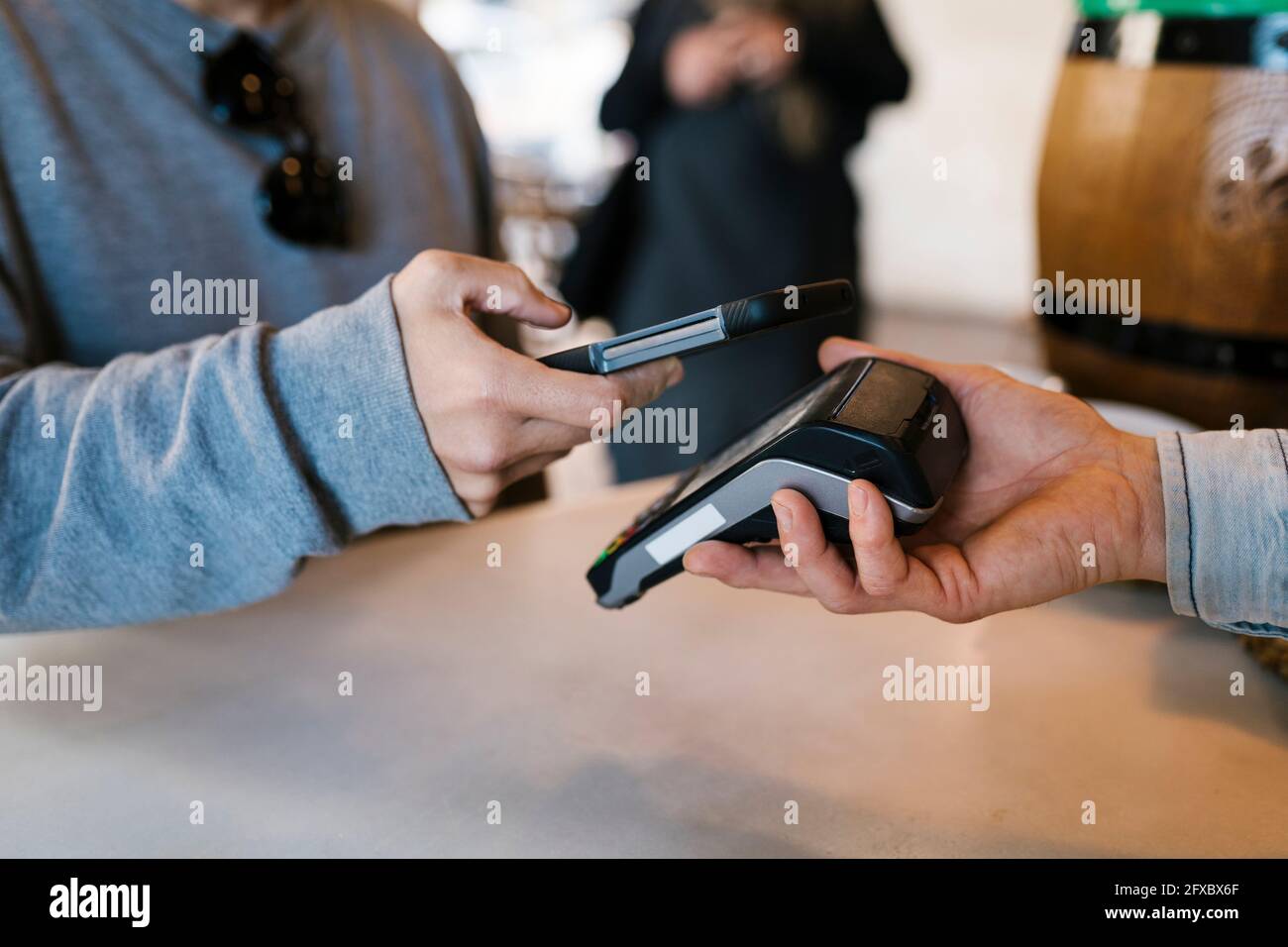 Customer paying through contactless payment by using smart phone at a ...