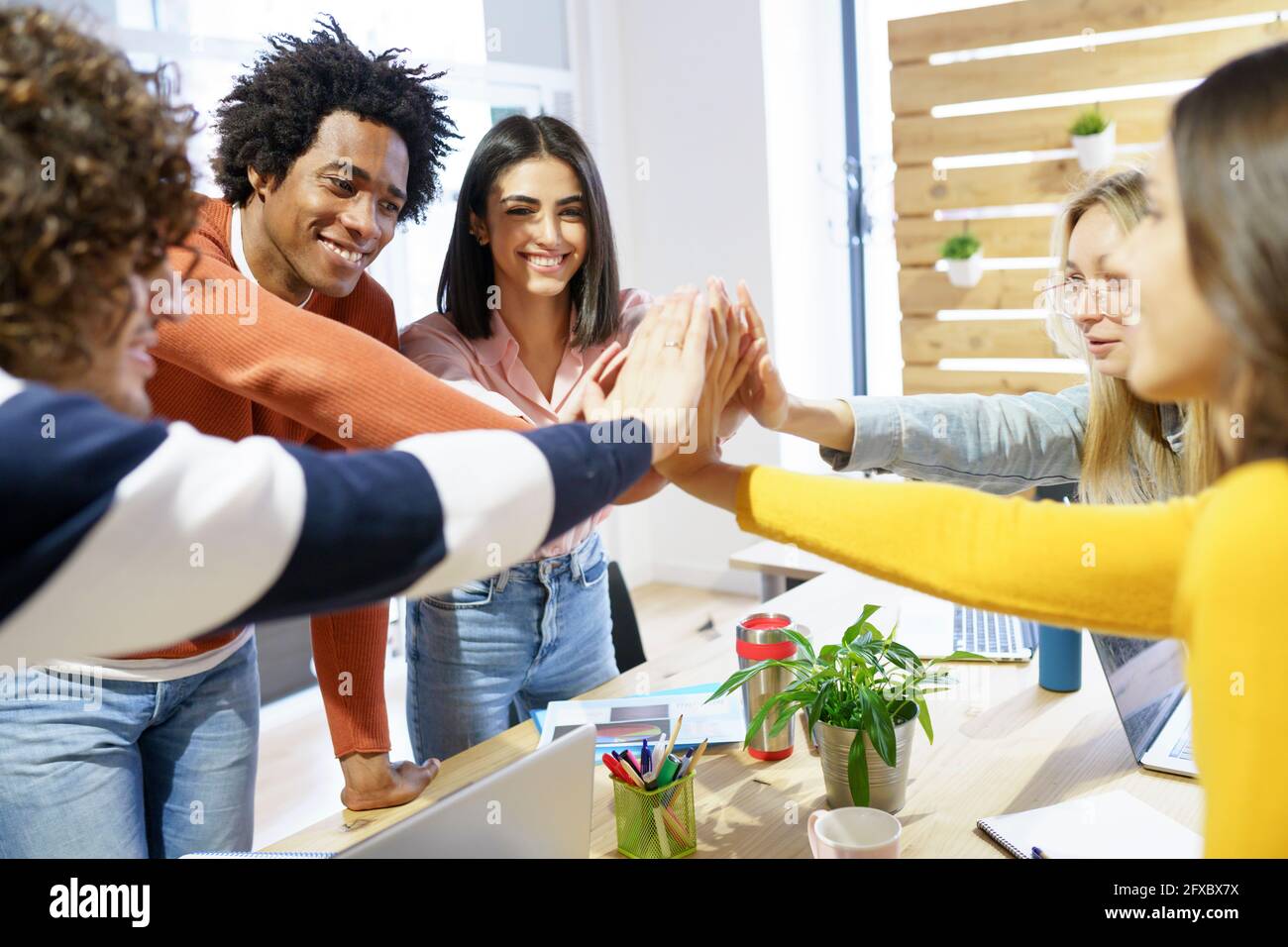 Colleagues cheering in office hi-res stock photography and images - Alamy