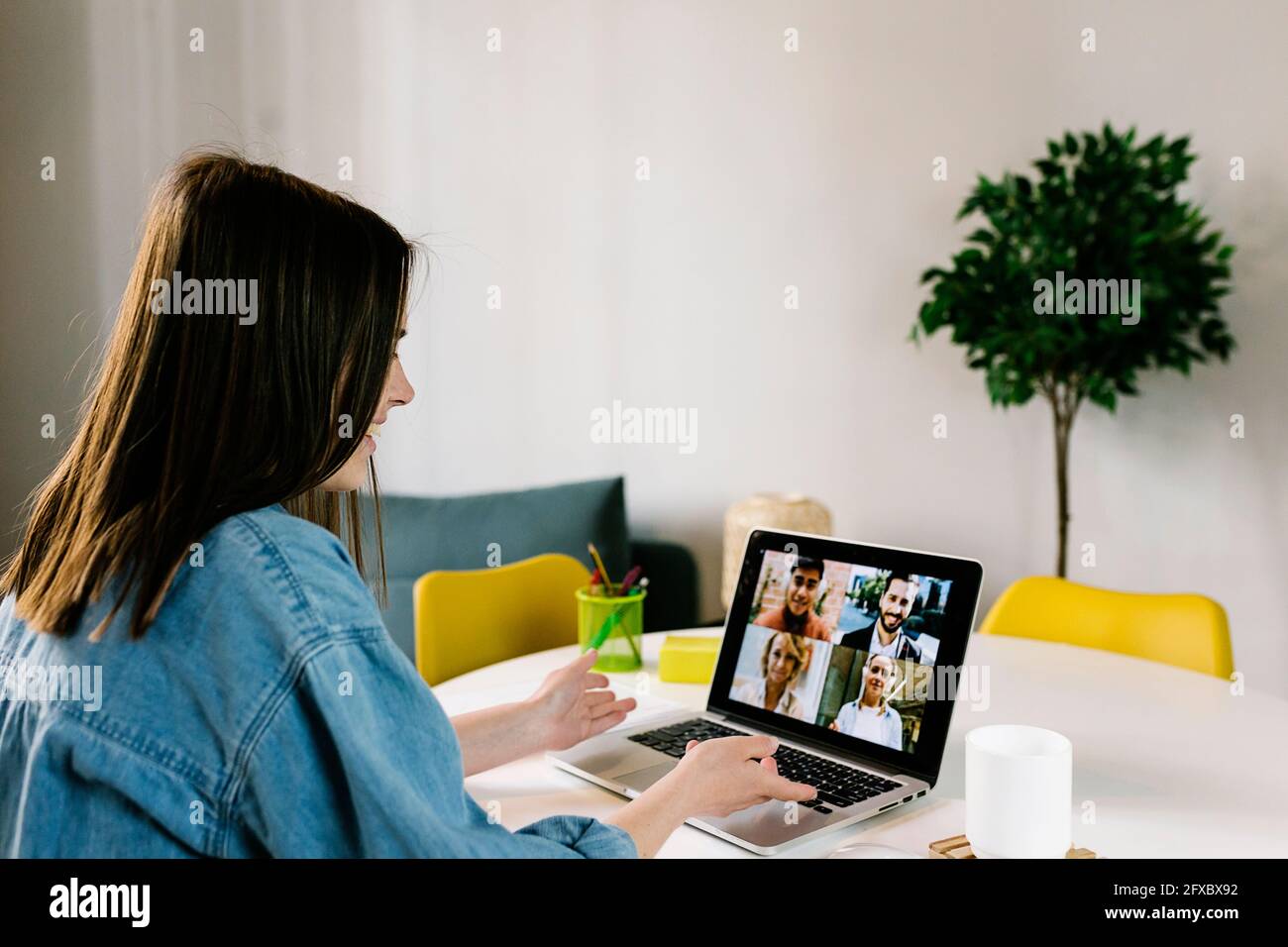 Female professional discussing during video conference through laptop ...