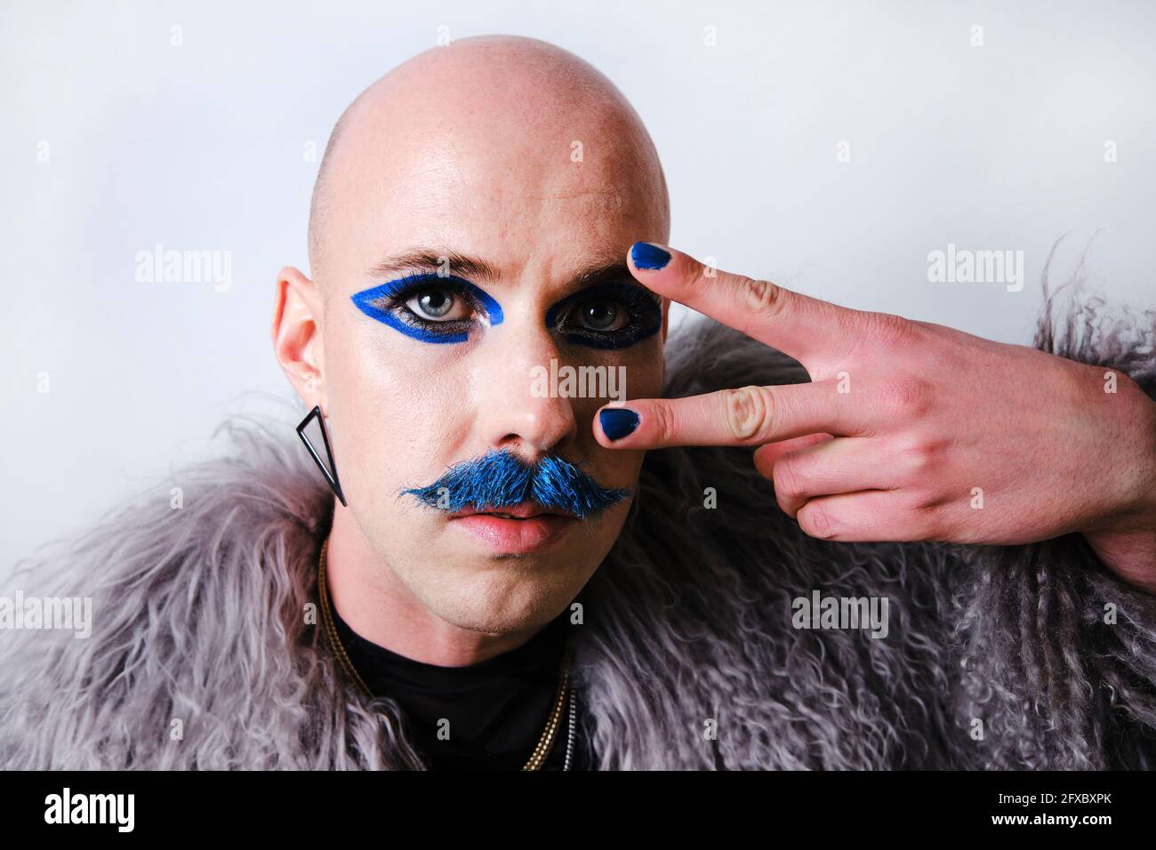 Man with mustache showing peace sign over white background Stock Photo ...