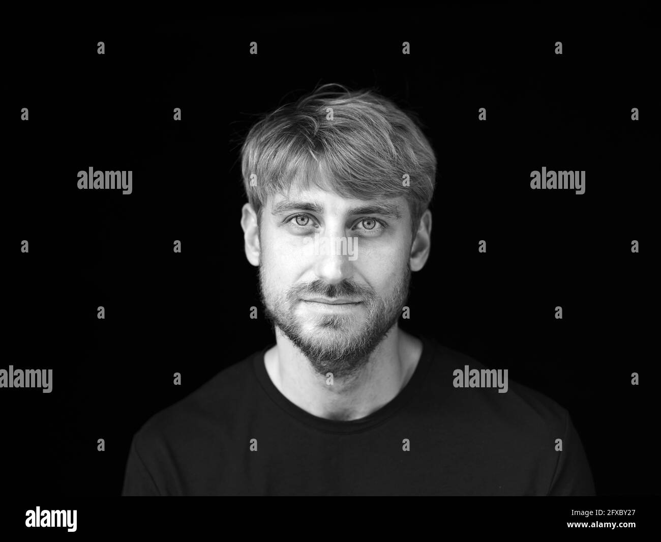 Handsome mid adult man against black background Stock Photo - Alamy