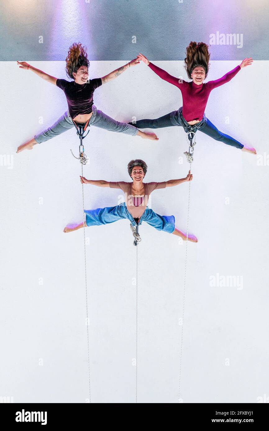 Multi-ethnic female dancers doing rehearsal together on rope in dance ...