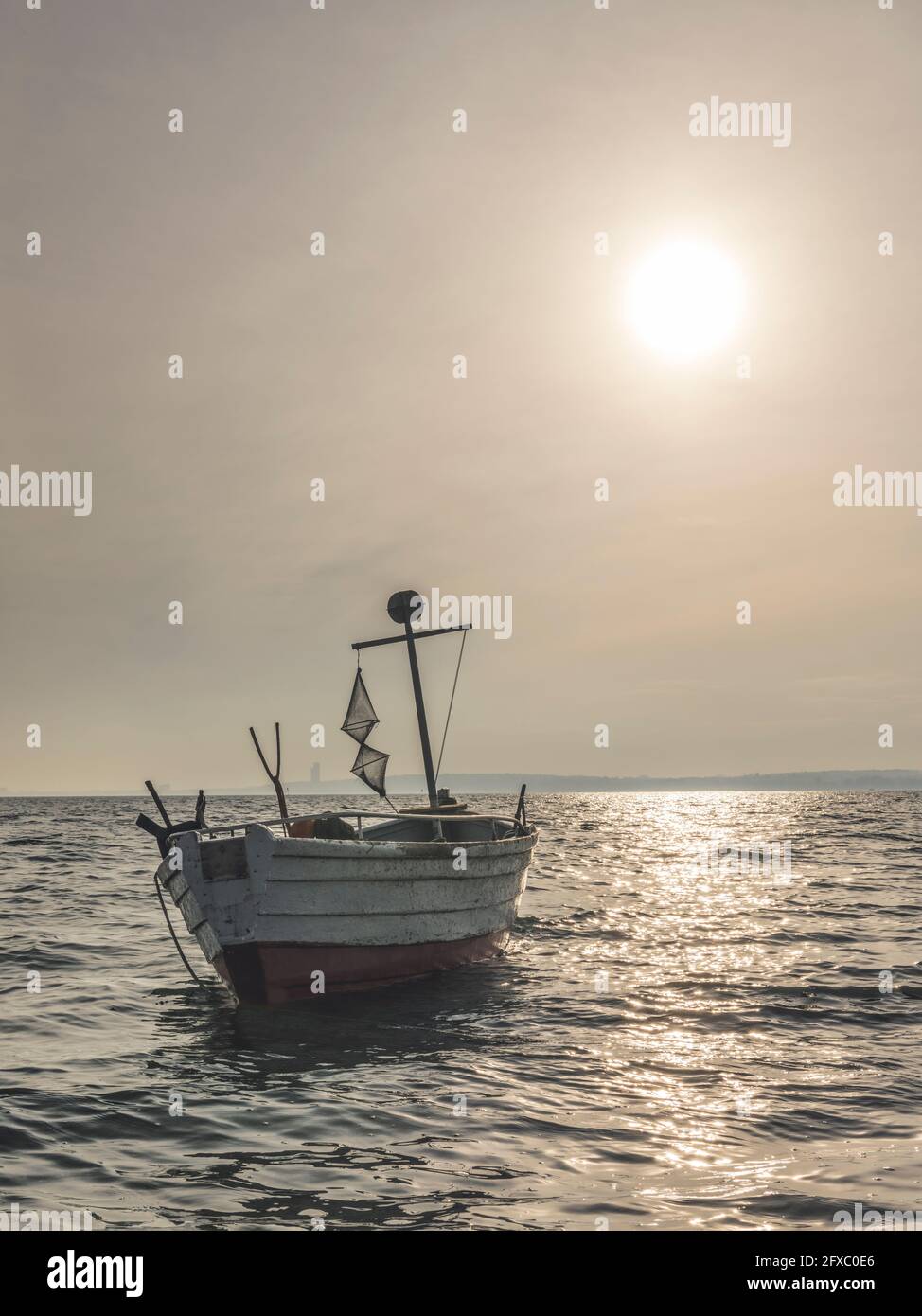 Sunset over boat on sea hi-res stock photography and images - Alamy