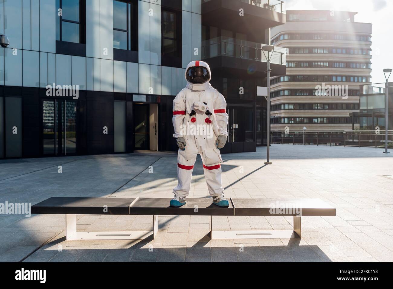 Male astronaut standing on bench in city Stock Photo - Alamy
