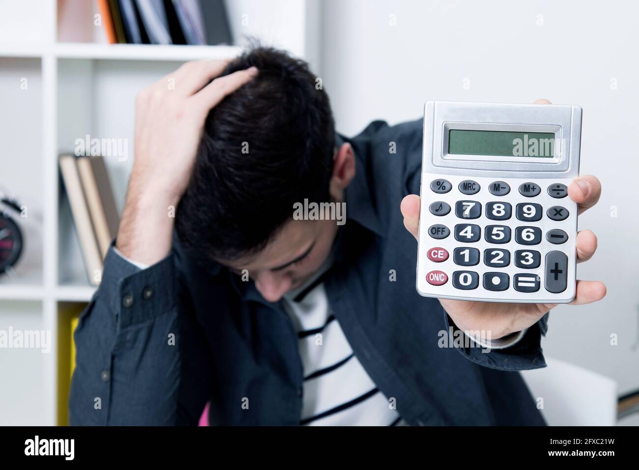 calculator with man problems Stock Photo - Alamy