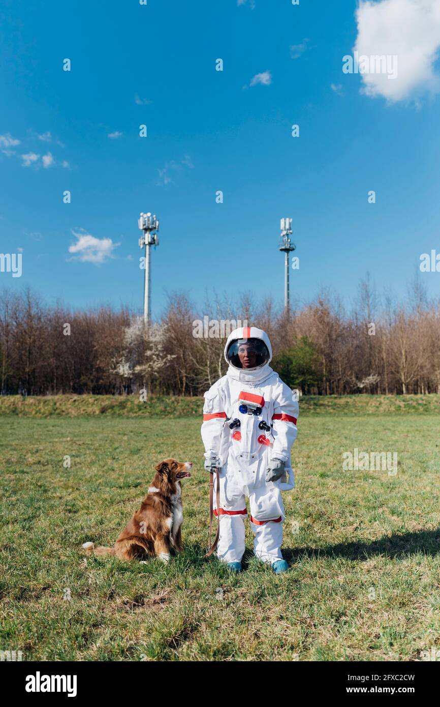 Female explorer standing with dog on sunny day Stock Photo - Alamy