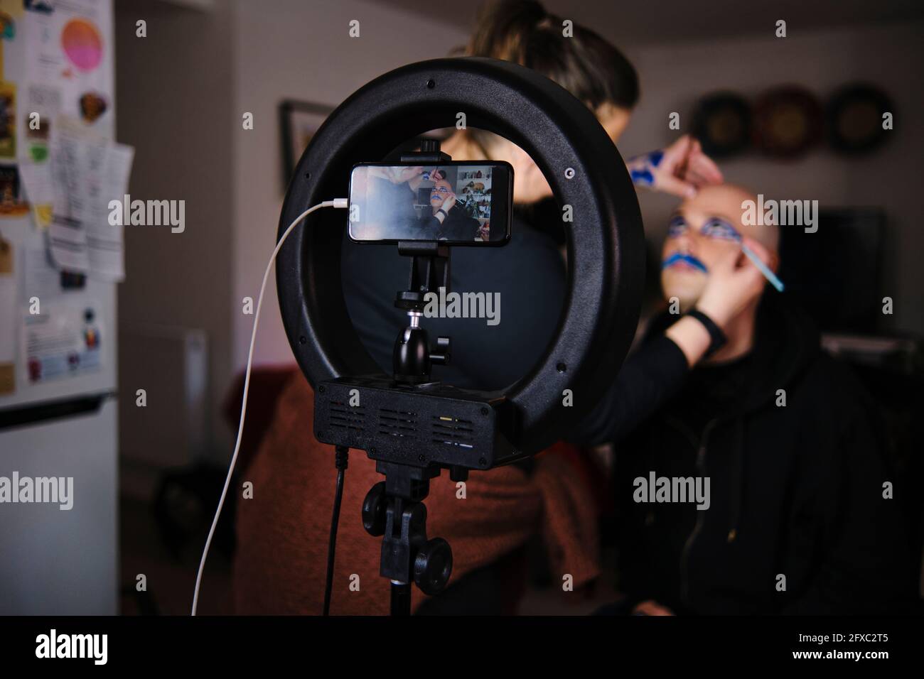 Make-up artist with model vlogging at studio Stock Photo - Alamy
