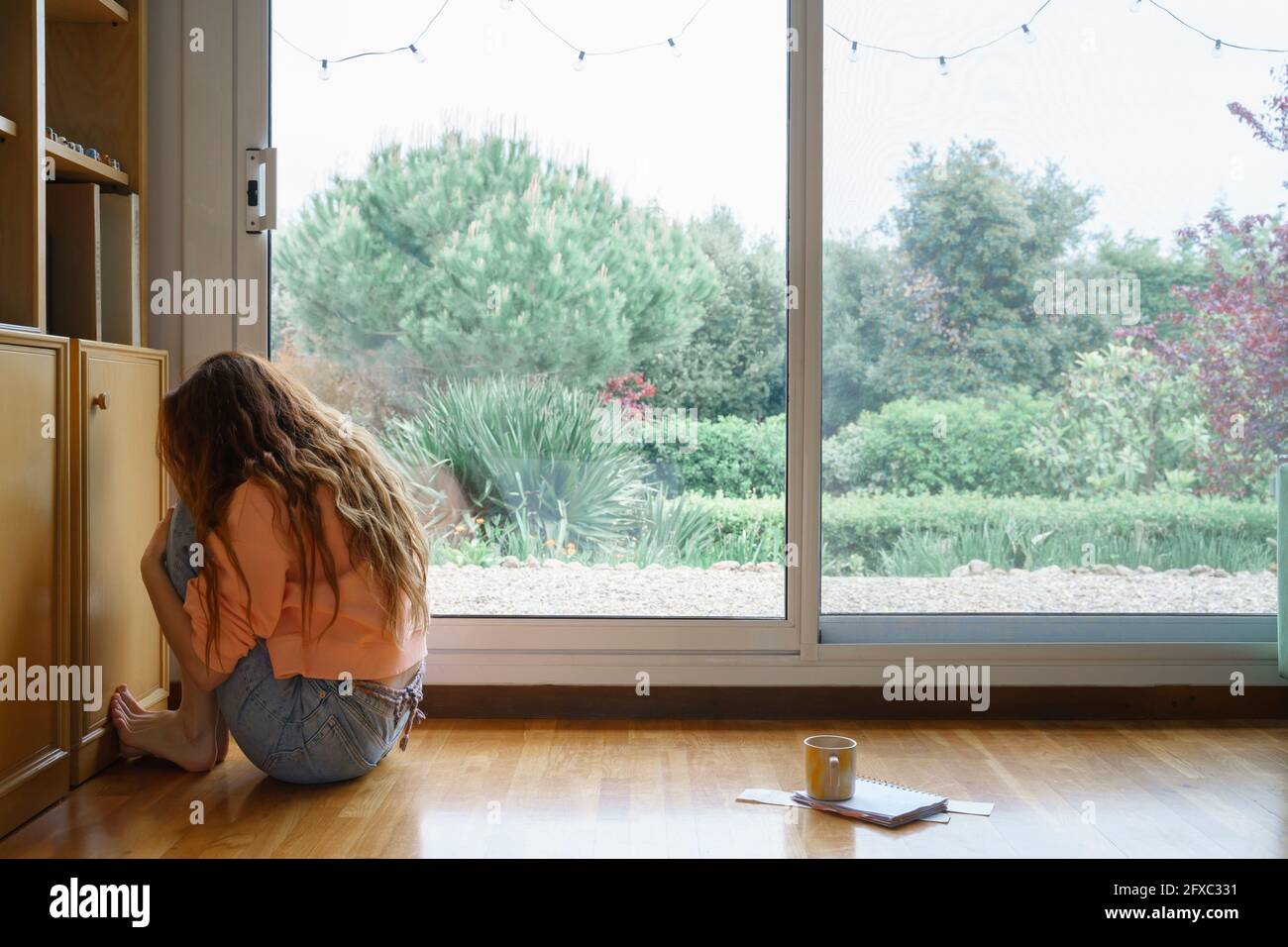 Woman hugging knees sad hi-res stock photography and images - Alamy