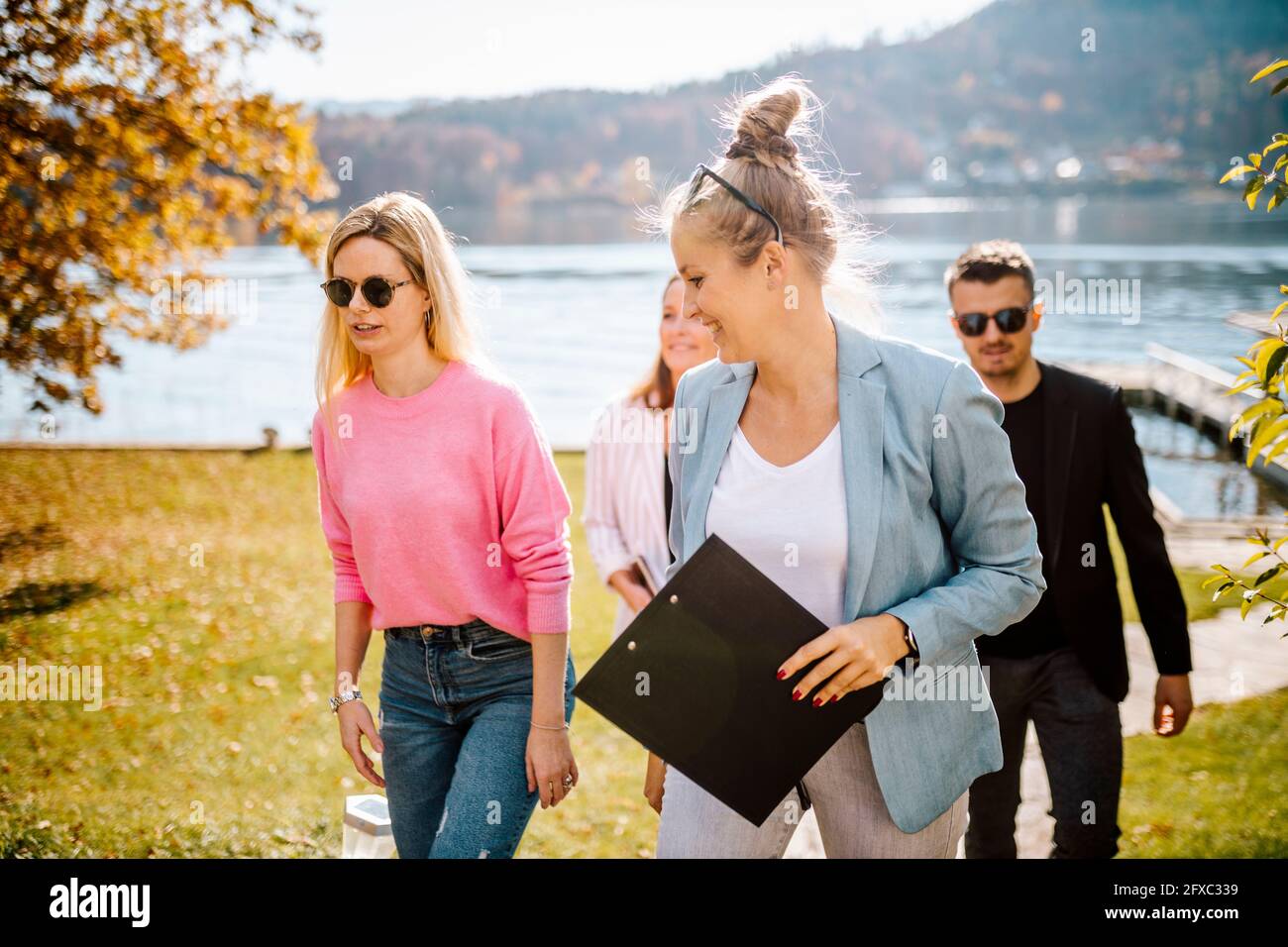 Customer walking with businesswomen while discussing in garden Stock ...