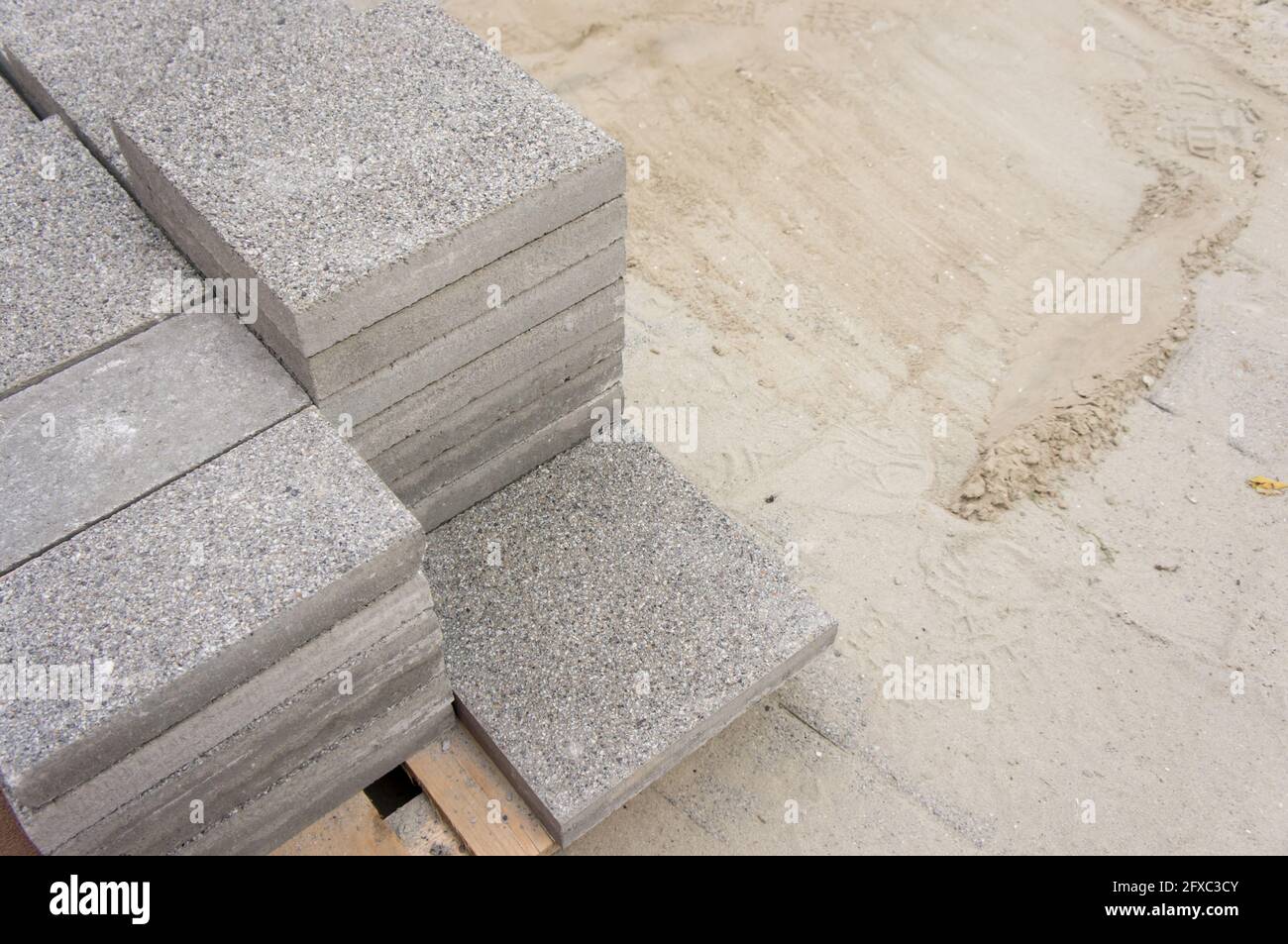 Square street tiles and sand Stock Photo - Alamy