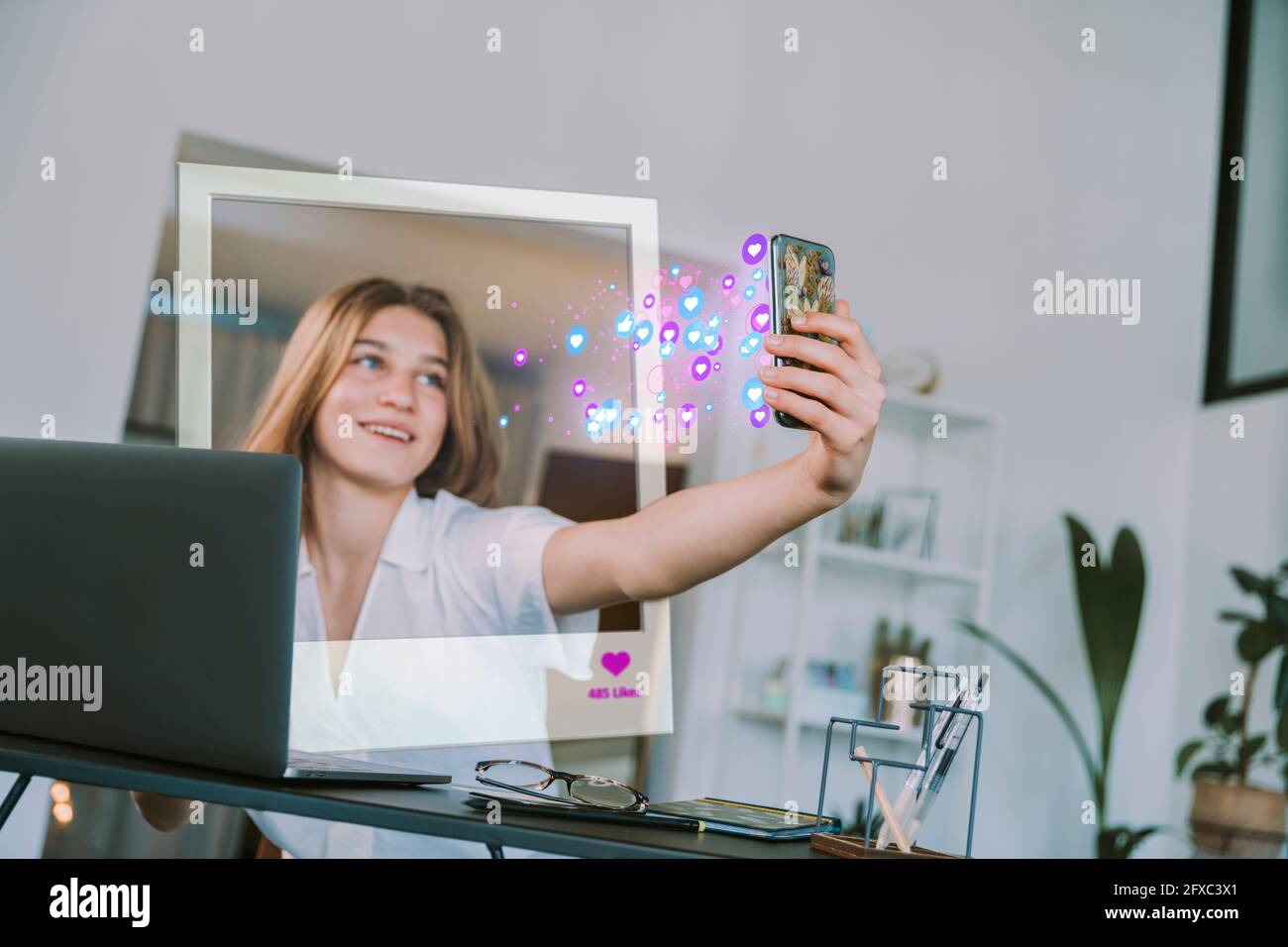 Teenage female influencer taking selfie through mobile phone with ...