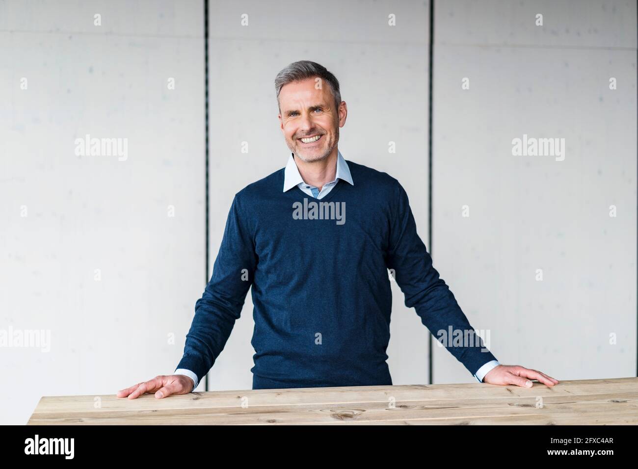 Mature caucasian man standing table hi-res stock photography and images ...