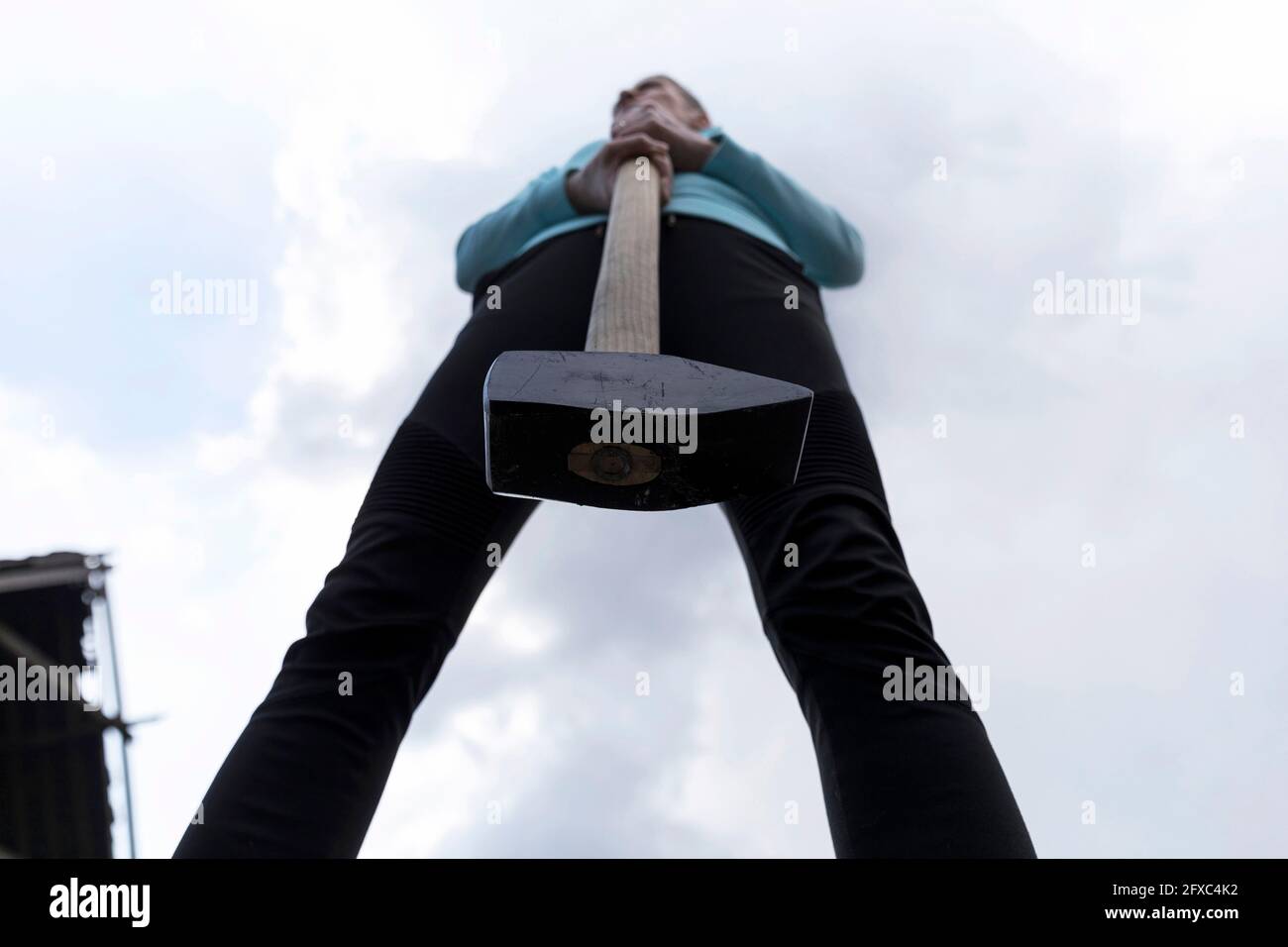 Mature woman standing with hammer Stock Photo - Alamy