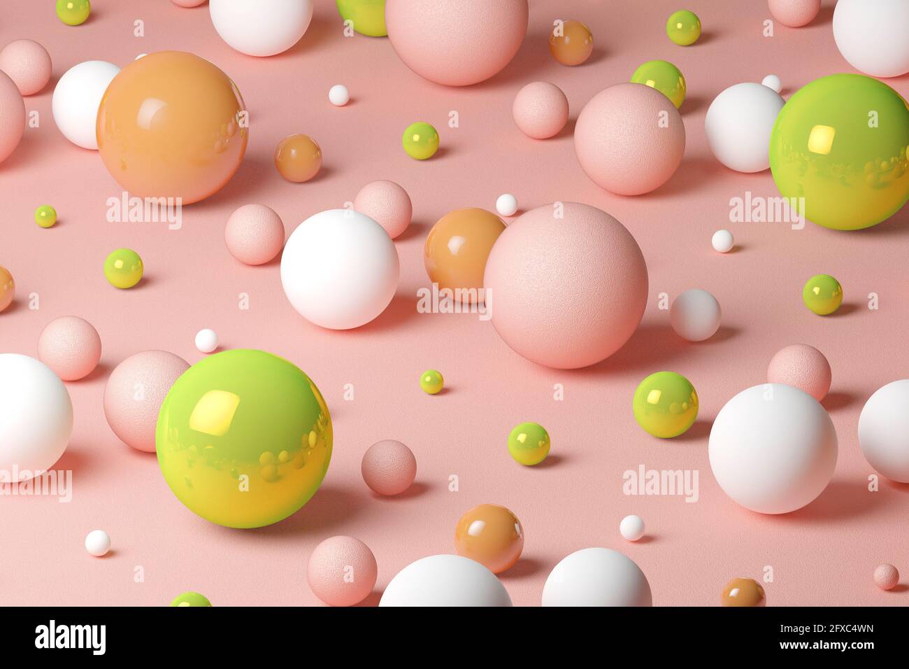 Three dimensional pattern of various spheres flat laid against pink ...