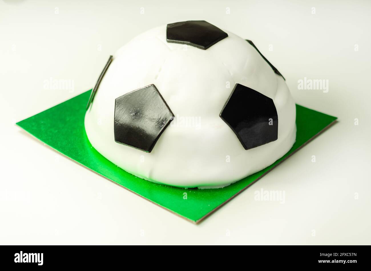 Football cake, sponge filled with frosting and raspberry jam, finished ...