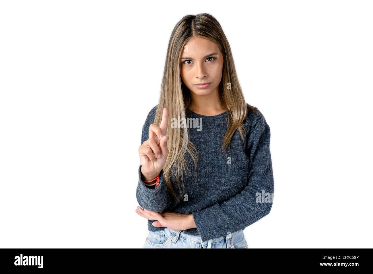 Attractive Latina woman with an angry or serious expression making a NO ...