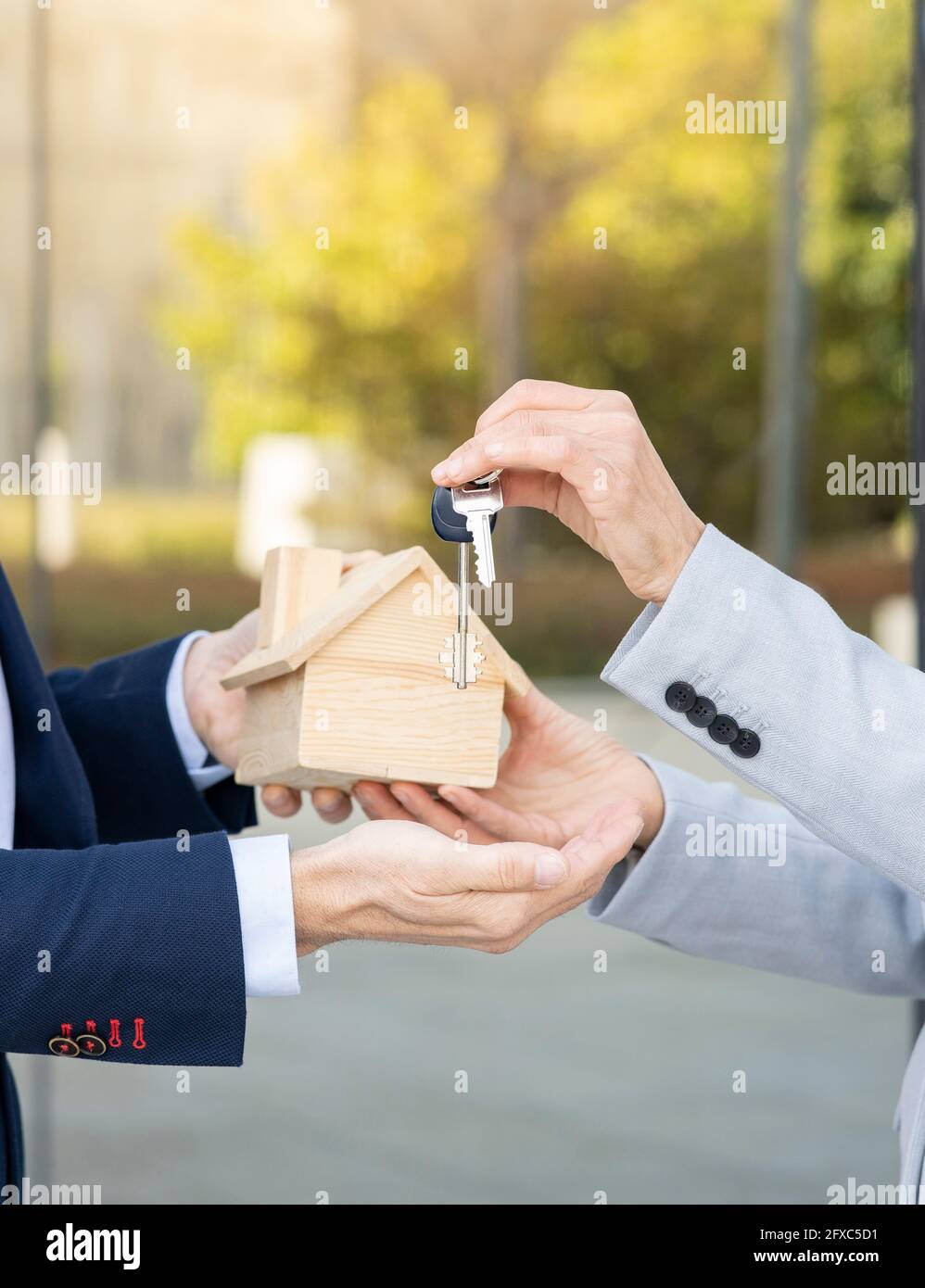 Businessman giving house key model hi-res stock photography and images ...