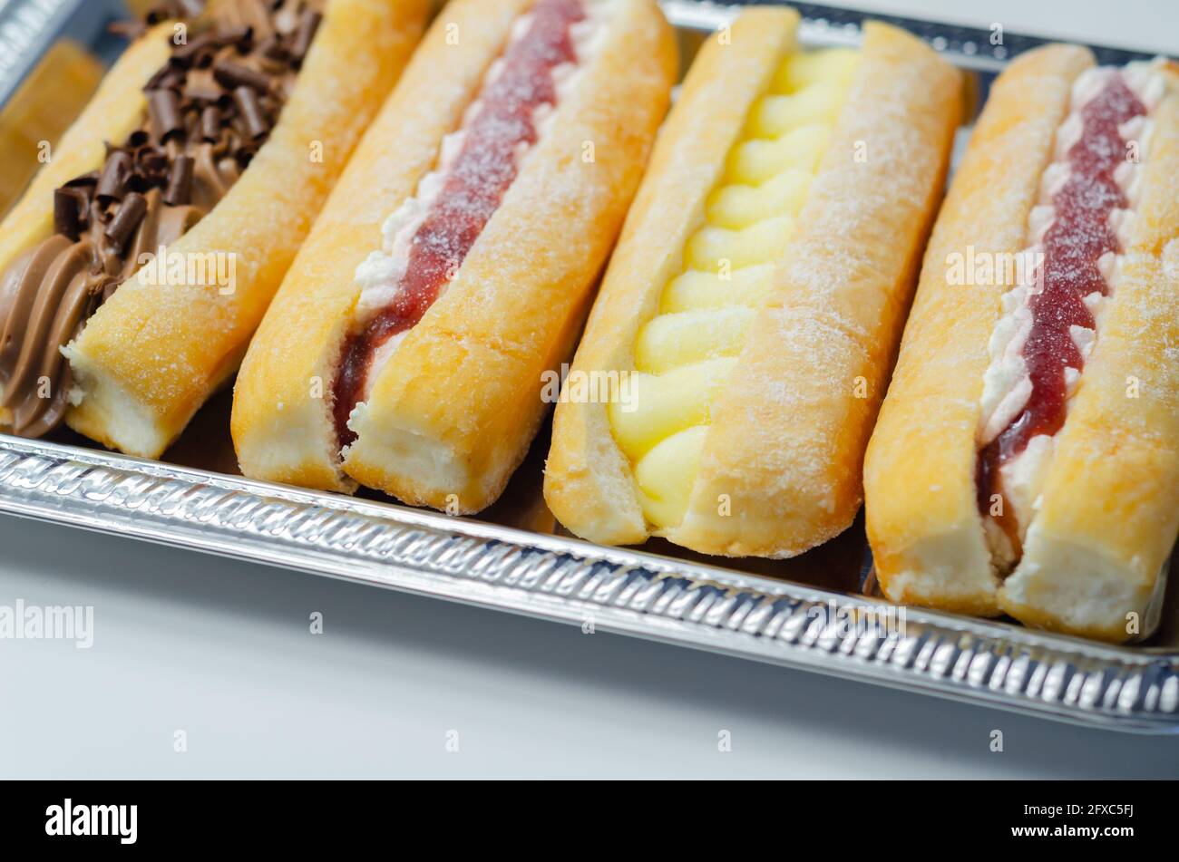 Mixed finger donuts filling chocolate, custard, jam and whipped cream ...