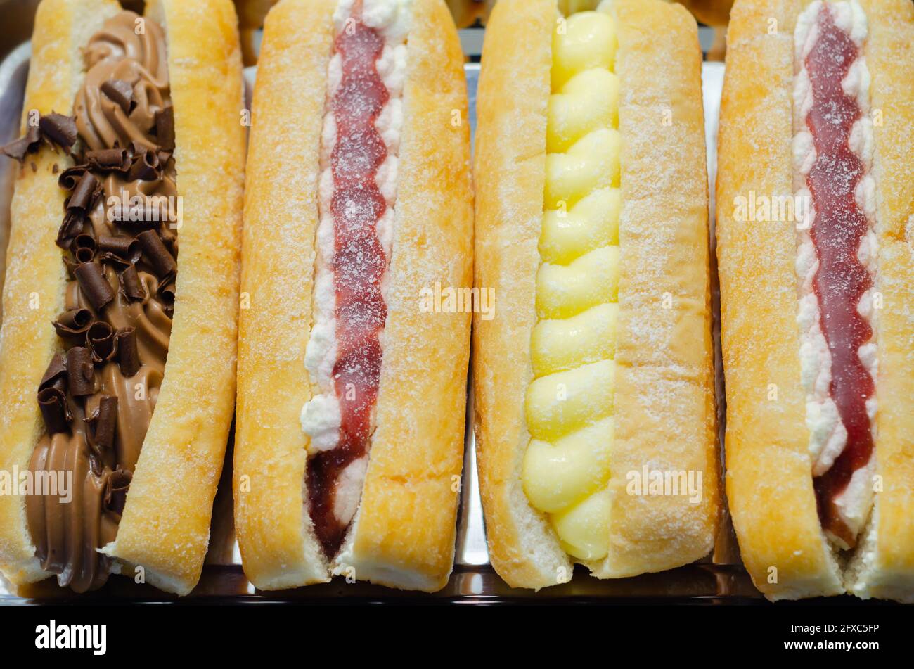 Mixed finger donuts filling chocolate, custard, jam and whipped cream ...