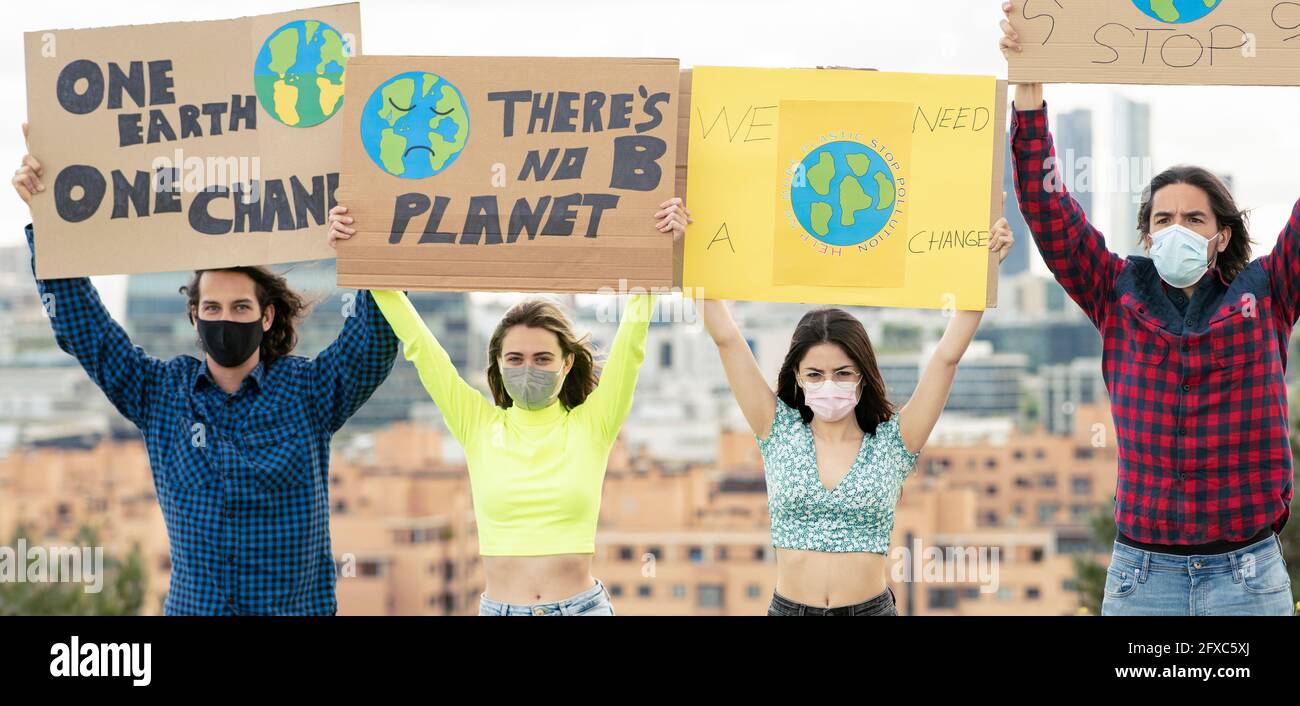 Activist standing with alertness poster on climate change Stock Photo ...