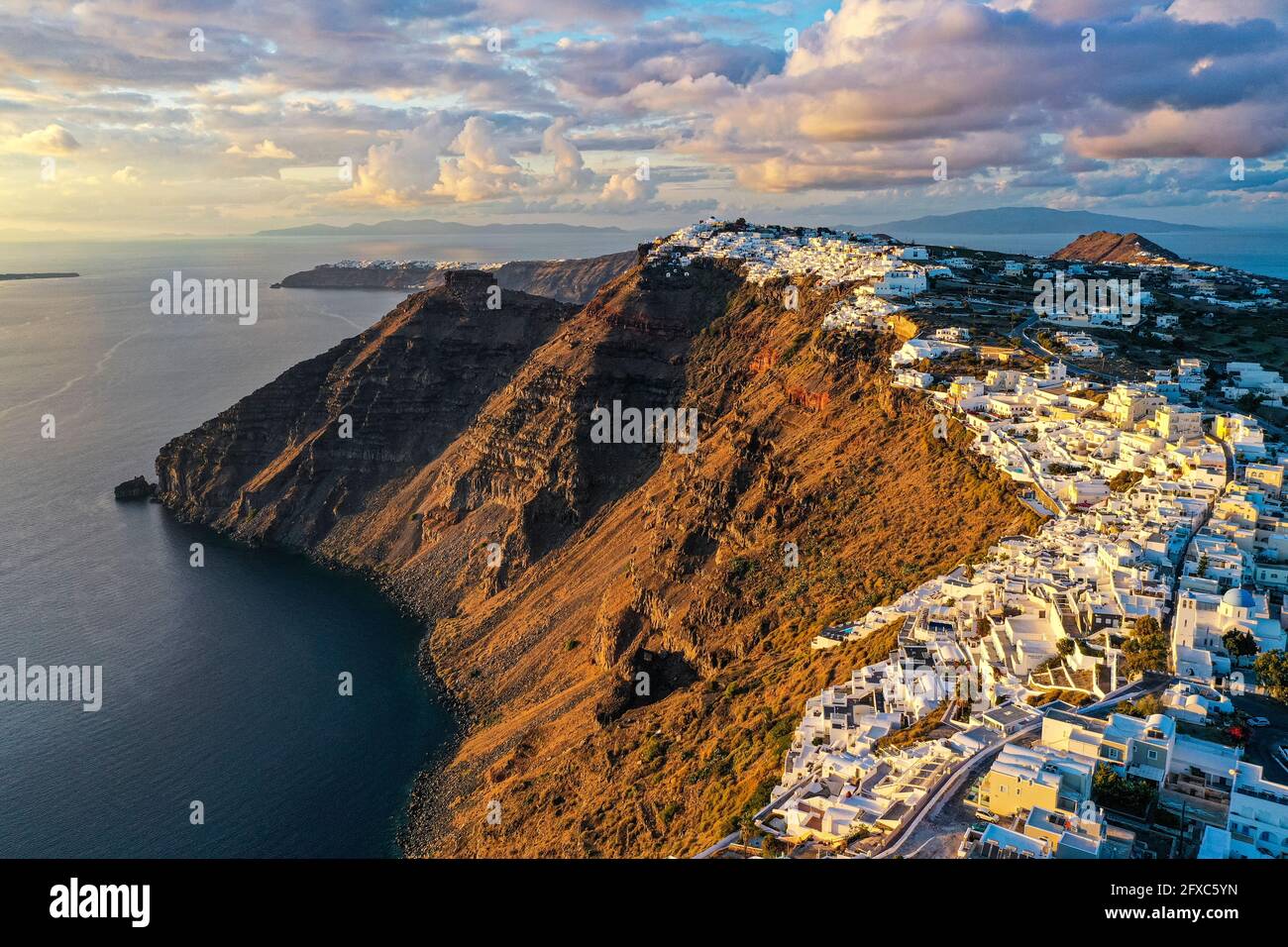 Greece, Santorini, Fira, Aerial view of town situated at edge of ...