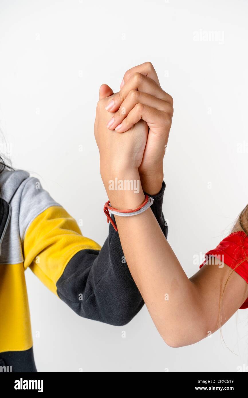 Two hands held together as a sign of companionship, giving each other ...