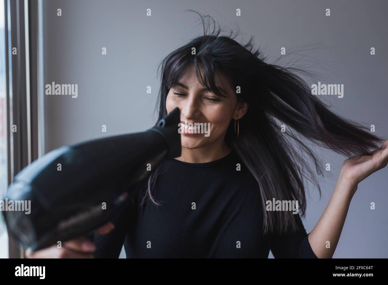 Woman drying hair home hi-res stock photography and images - Alamy