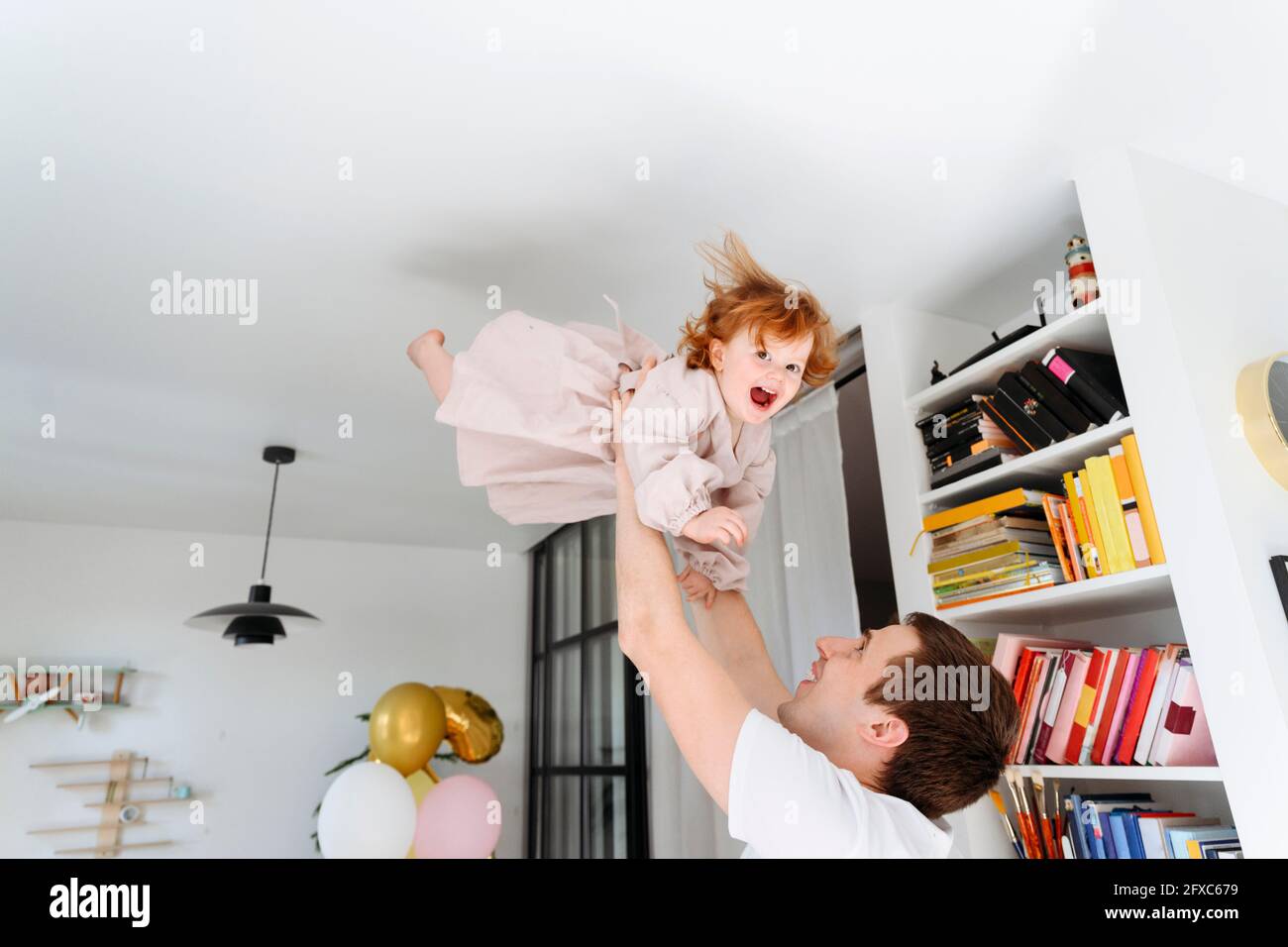 Adult lifting child shelf hi-res stock photography and images - Alamy