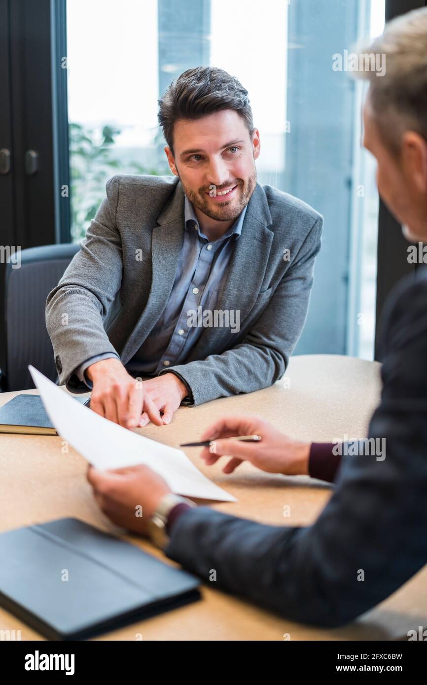 Male colleagues working documents hi-res stock photography and images ...