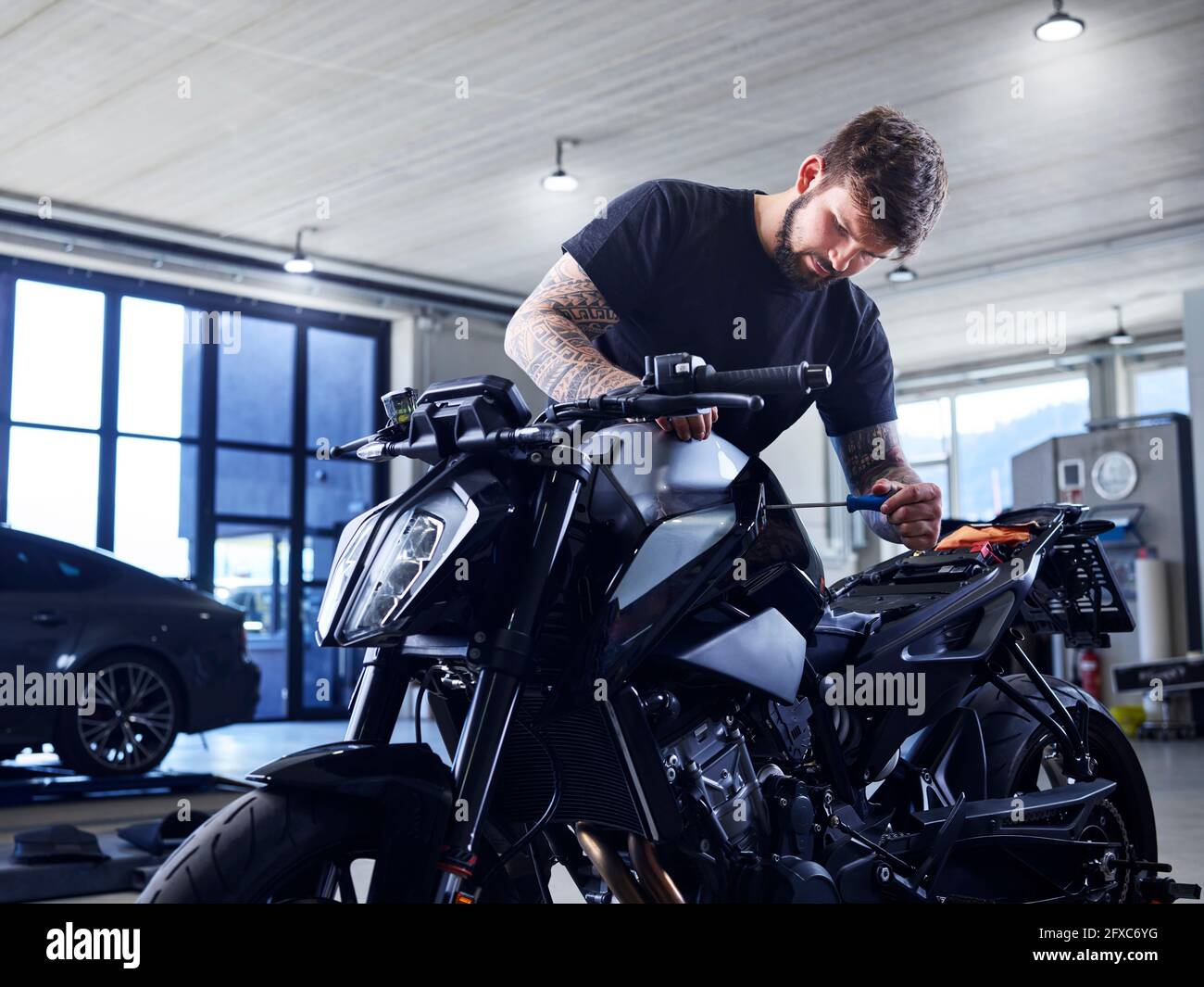 Young man working on motorbike hi-res stock photography and images - Alamy