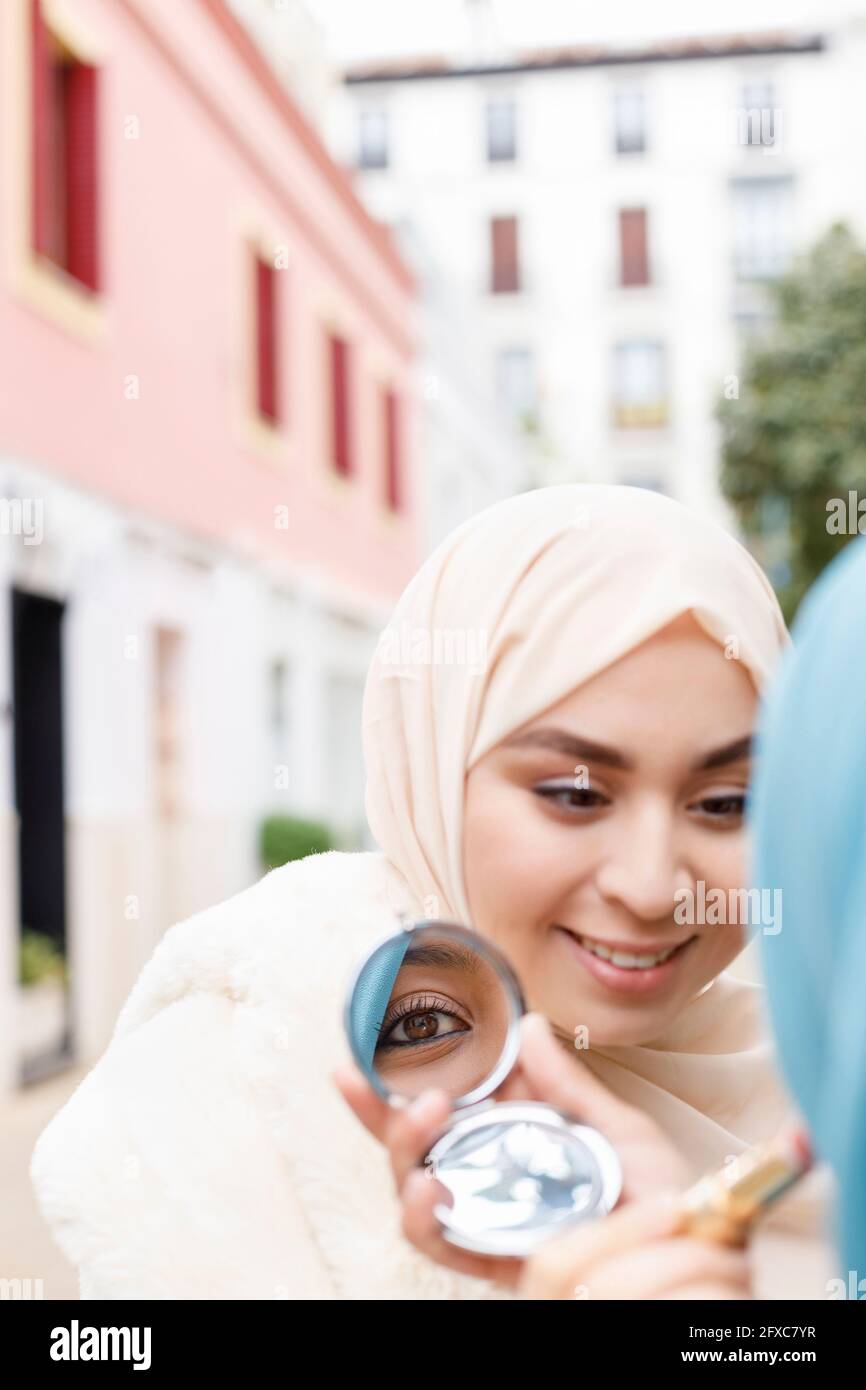 Young women friends applying makeup hi-res stock photography and images ...