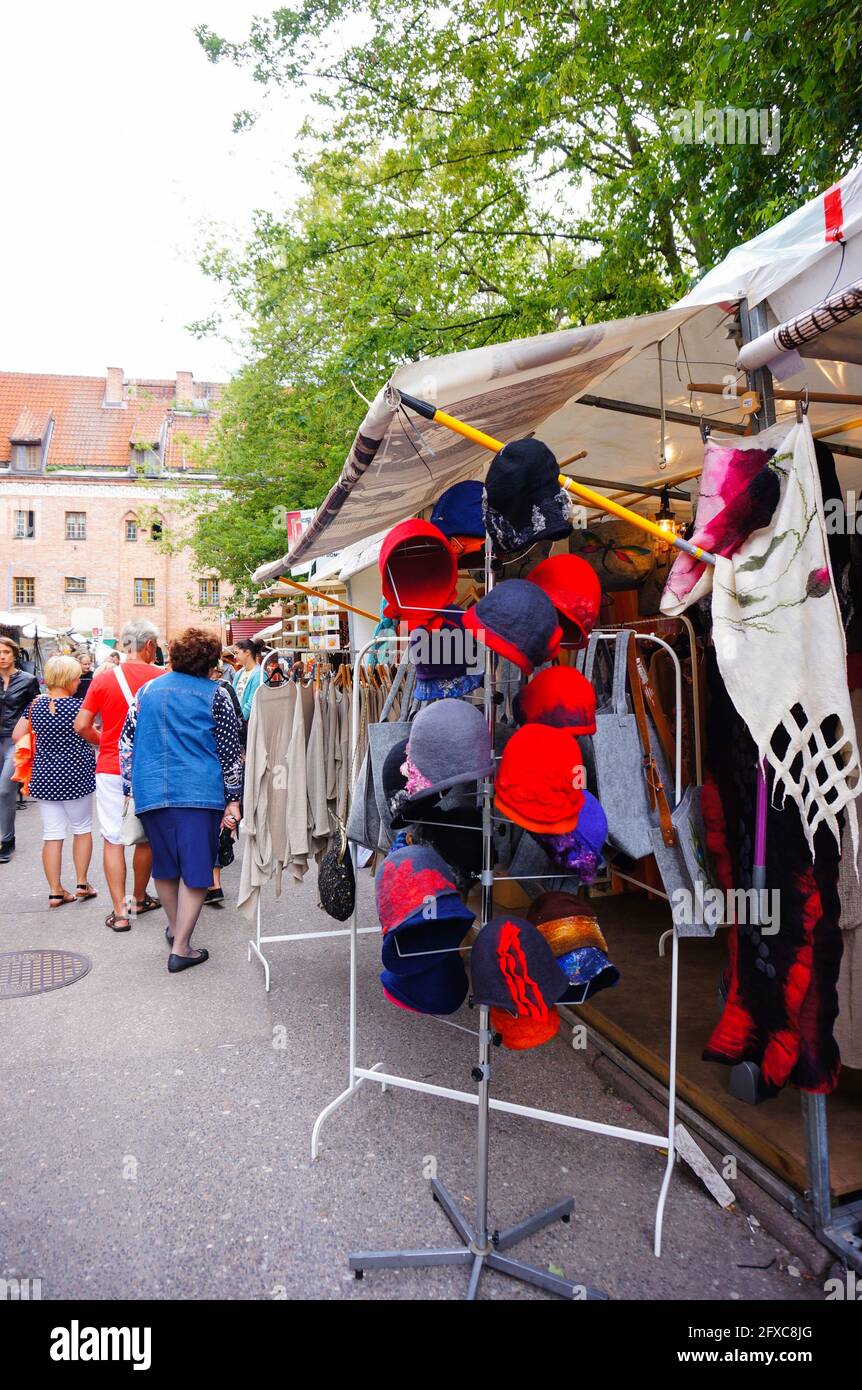 GDANSK, POLAND - Sep 22, 2015: Clothes and hats for sale at a market ...