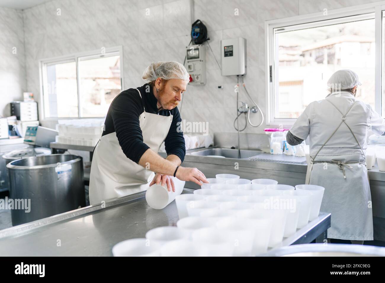 Mature chef couple working in dairy factory Stock Photo - Alamy