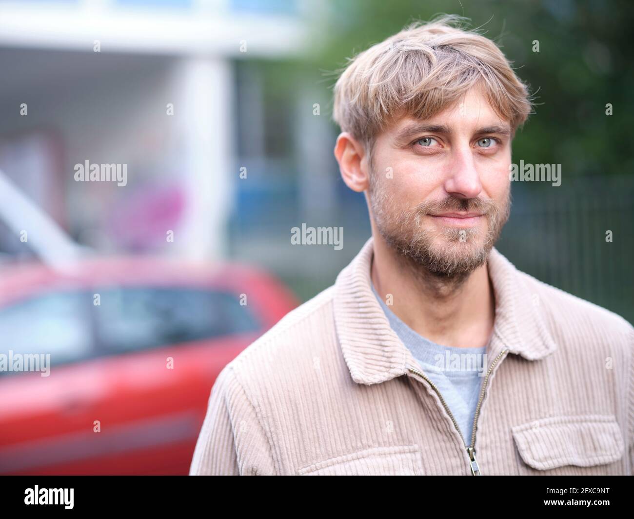 Handsome man with gray eyes standing Stock Photo - Alamy