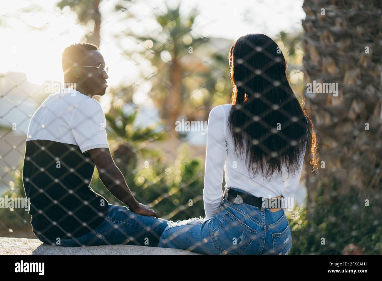 Two Couple Sitting On Fence High Resolution Stock Photography and ...