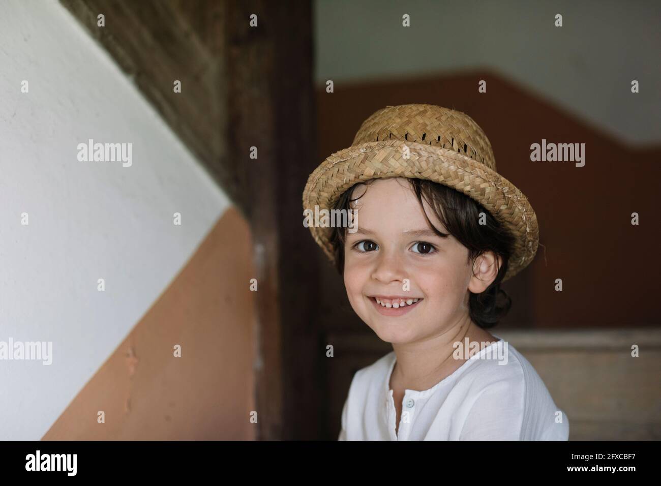 Cute boy wearing hat smiling at home Stock Photo - Alamy