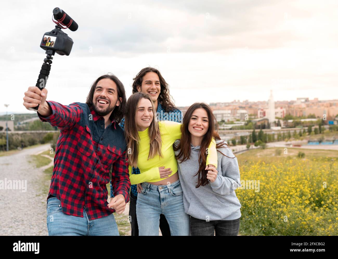 Male influencer vlogging with friends in nature Stock Photo - Alamy