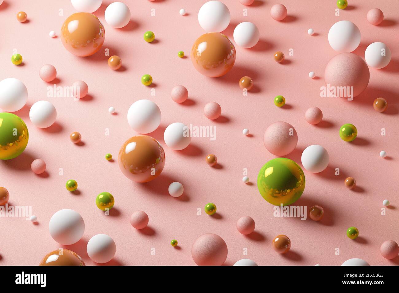 Three dimensional pattern of various spheres flat laid against pink ...