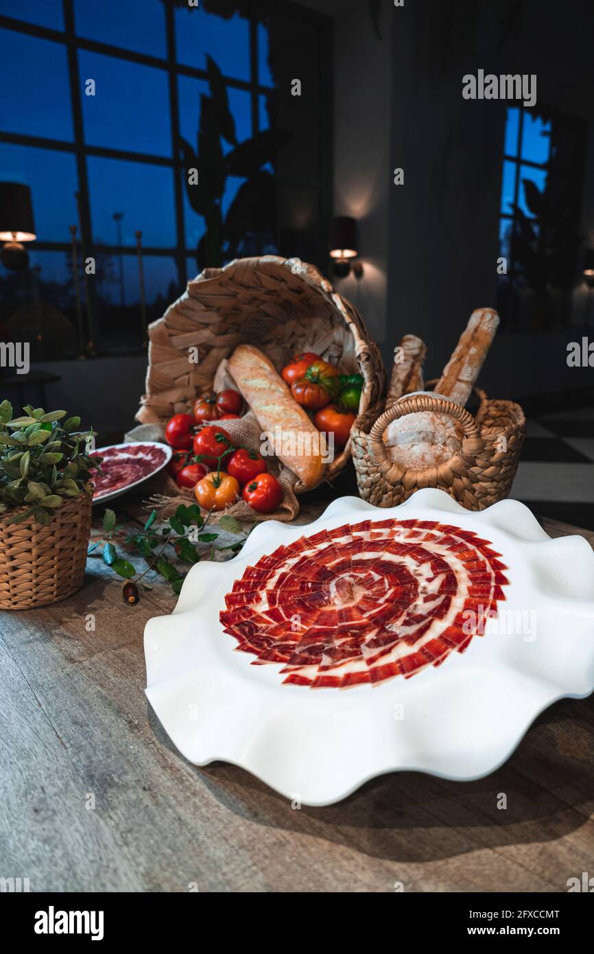 Red meat slice in pattern on flower shape plate by vegetable at ...