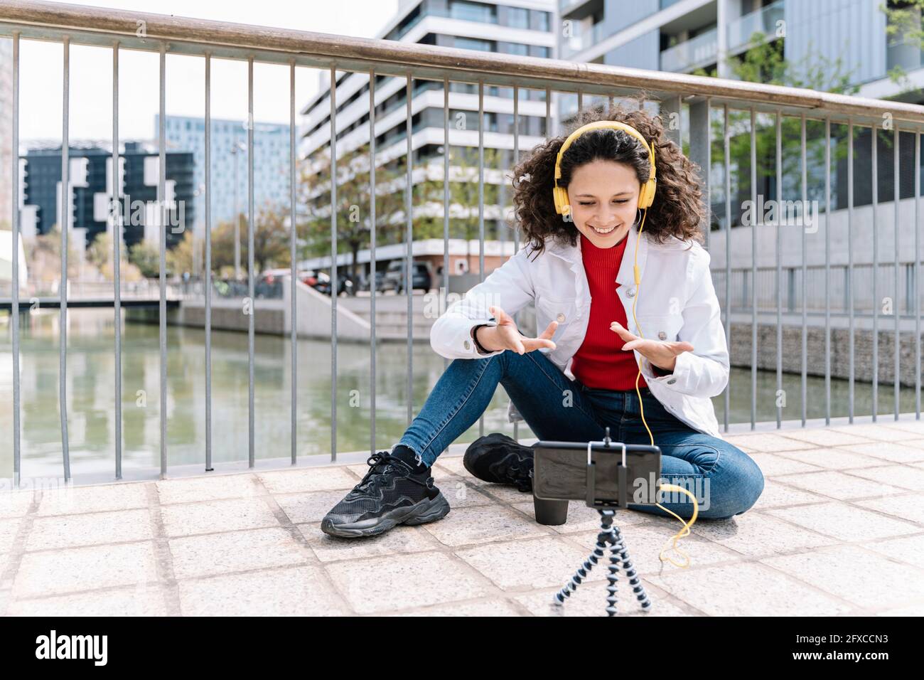 Hispanic female influencer gesturing during video call on smart phone ...